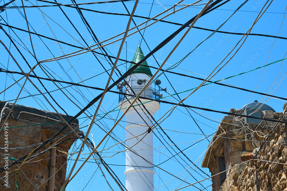 Power lines, a messy mess of power lines between houses in the ancient ...