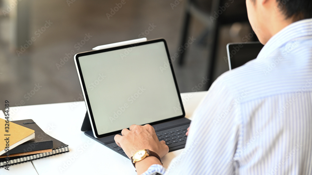 Photo of young smart man working as accountant typing on white blank ...