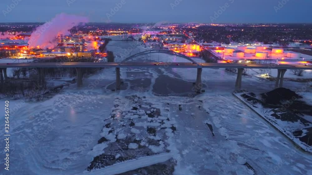 Scenic highway bridge predawn, dynamic aerial view with city lights and ...