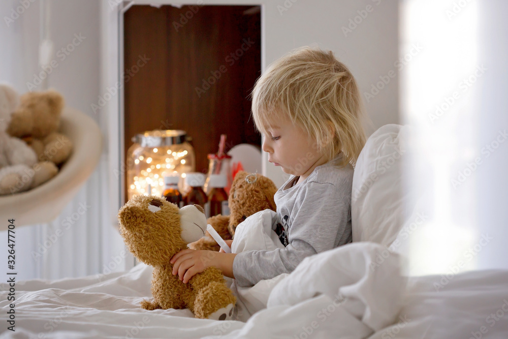 Sick child boy lying in bed with a fever, resting Stock Photo | Adobe Stock