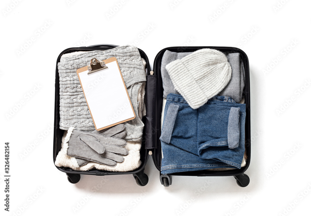 Flat lay with open suitcase with casual clothes for autumn, winter ...
