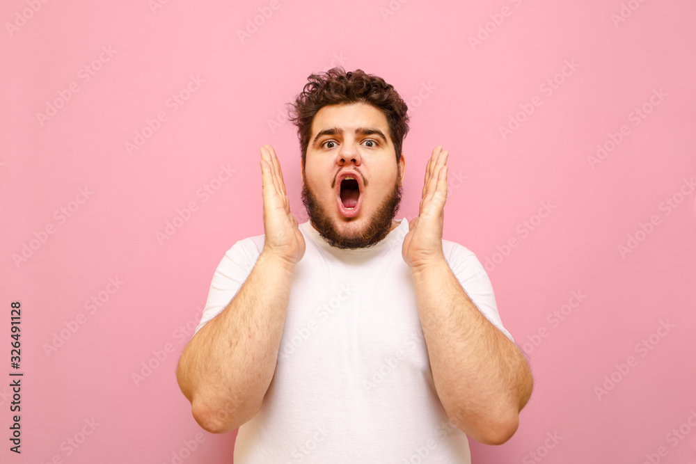 Portrait Of Shocked Young Man With Curly Hair And Beard With Shocked