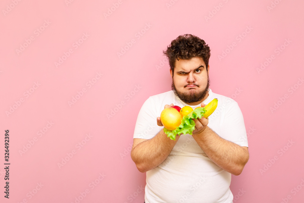 Positive fat man with funny face isolated on pink background with ...