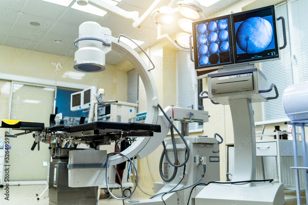 Operating theater with working equipment, lights and computers ready ...