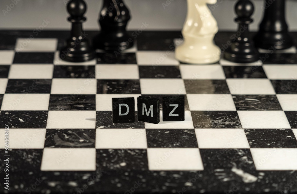 The acronym DMZ for demilitarized zone represented by black and white ...