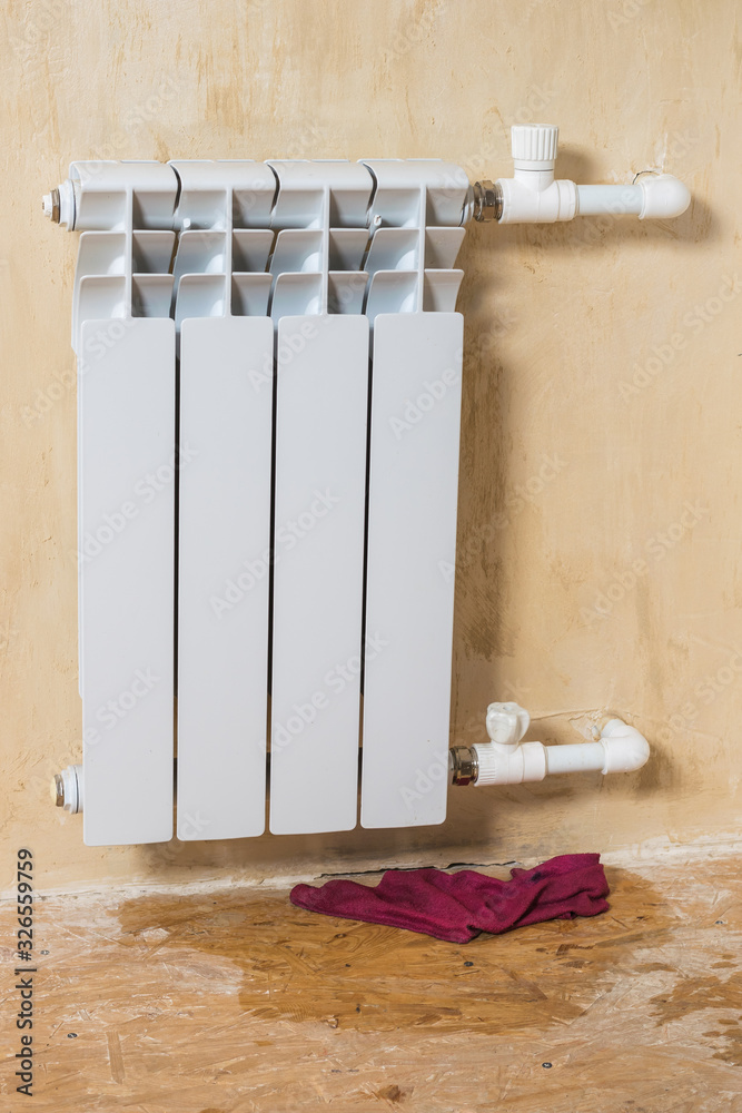 A red rag under a leaking radiator in a private home. Accident of the ...