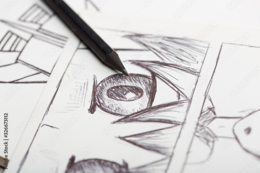 Artist drawing an anime comic book in a studio. Stock Photo | Adobe Stock