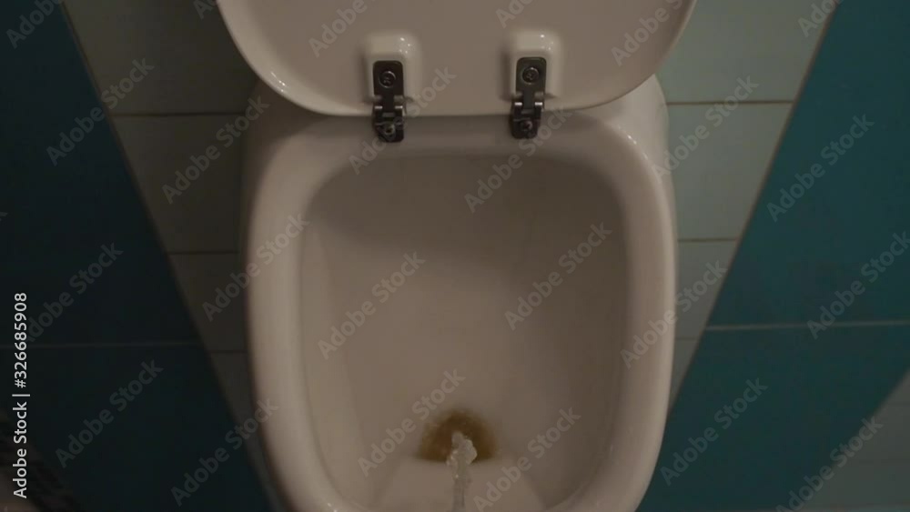 Man point of view while peeing in the urinal. Male urinating and ...
