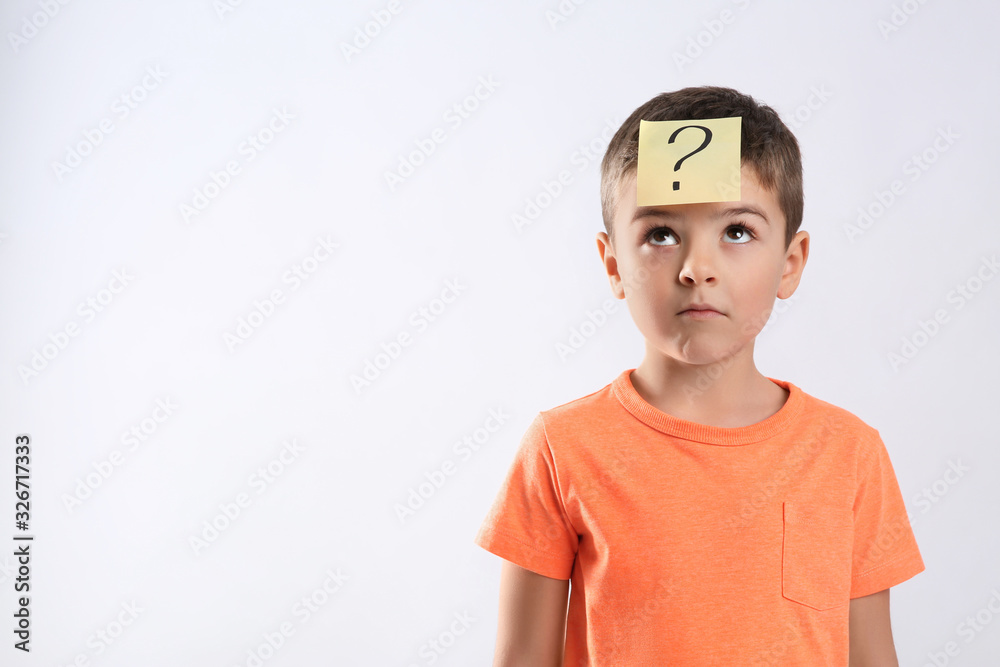 Emotional little boy with question mark on white background Stock Photo ...