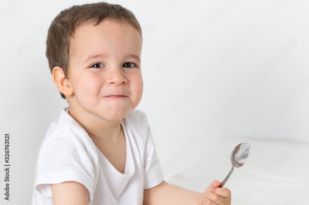 little boy eating and smiling in the kitchen Stock Photo | Adobe Stock