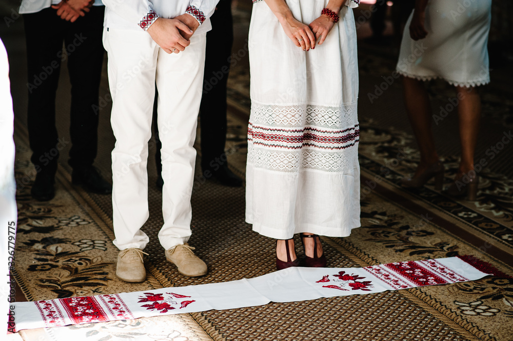 The legs of the bride and groom become on embroidered towel ...