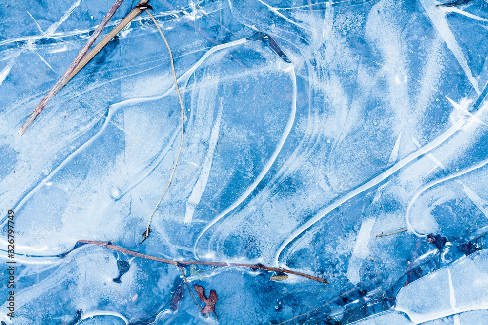 Colorful ice texture with air bubbles and fault lines. Frozen water on ...