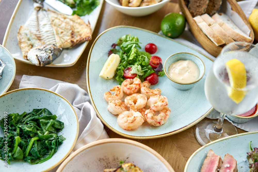 Many different delicious dishes dishes on the table. Various snacks and ...