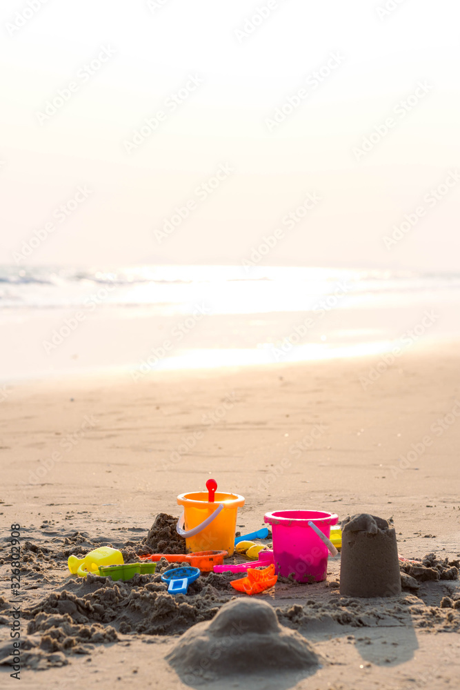 Plastic sandbox toys on the sand. kids toys on tropical sand beach ...