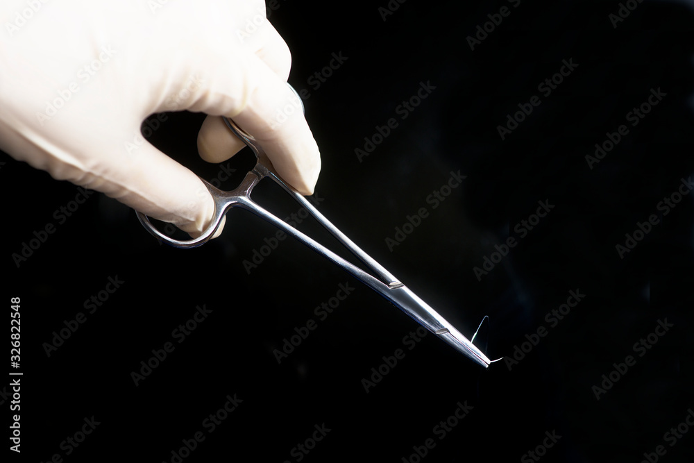 Gloved Hand With Needle Holder Forceps And Suture Stock Photo | Adobe Stock