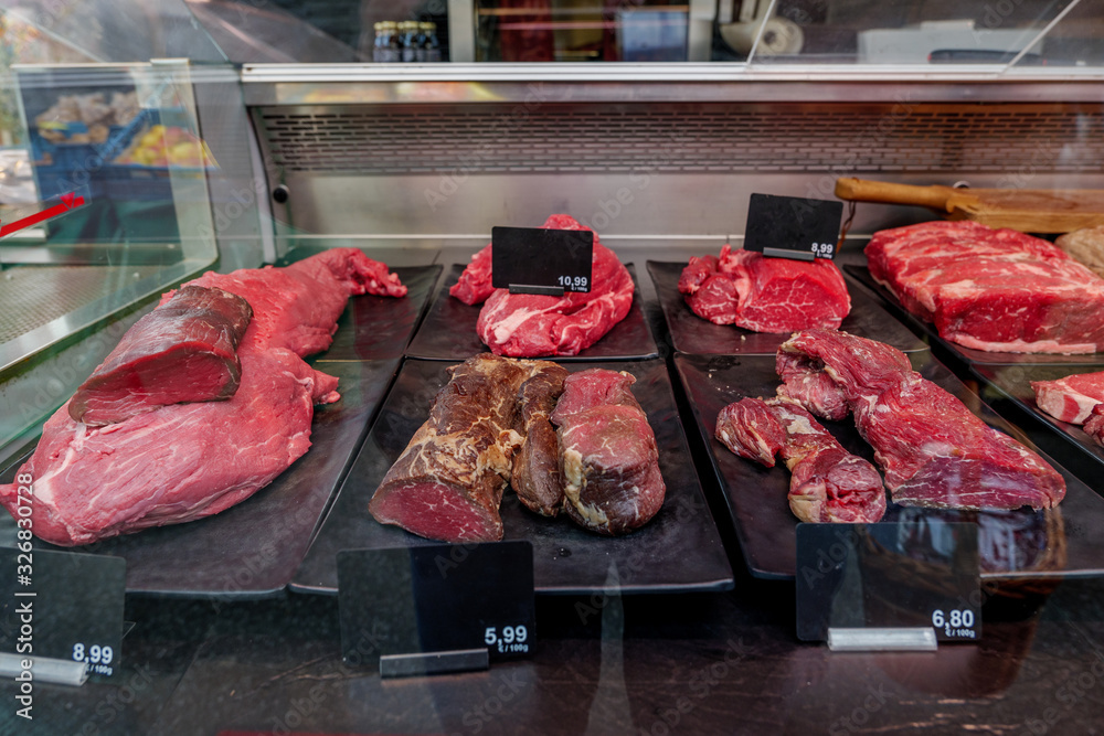 Front view at display counter of butcher shop with various type of ...