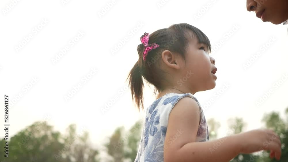 Upset Asian little child daughter feel hurt and avoid talking with her ...