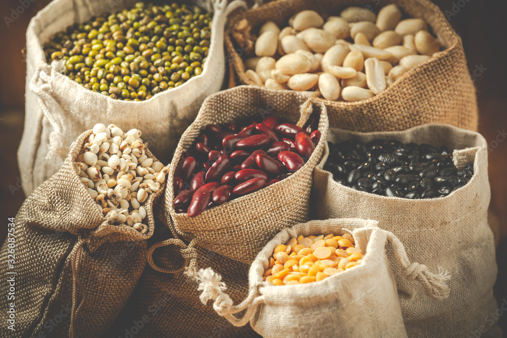 Various types of beans lined up in sacks. Stock Photo | Adobe Stock