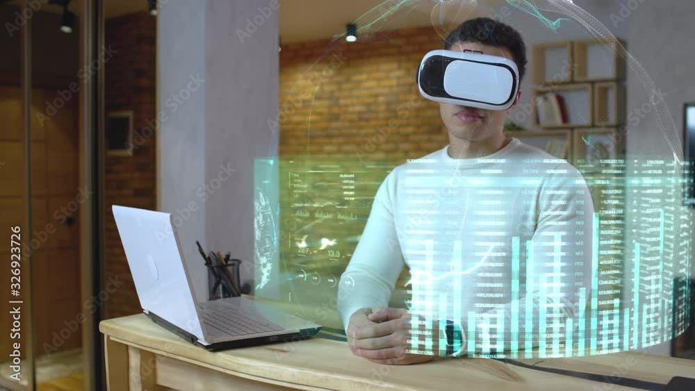 Man examining financial charts wearing vr set, futuristic tech ...