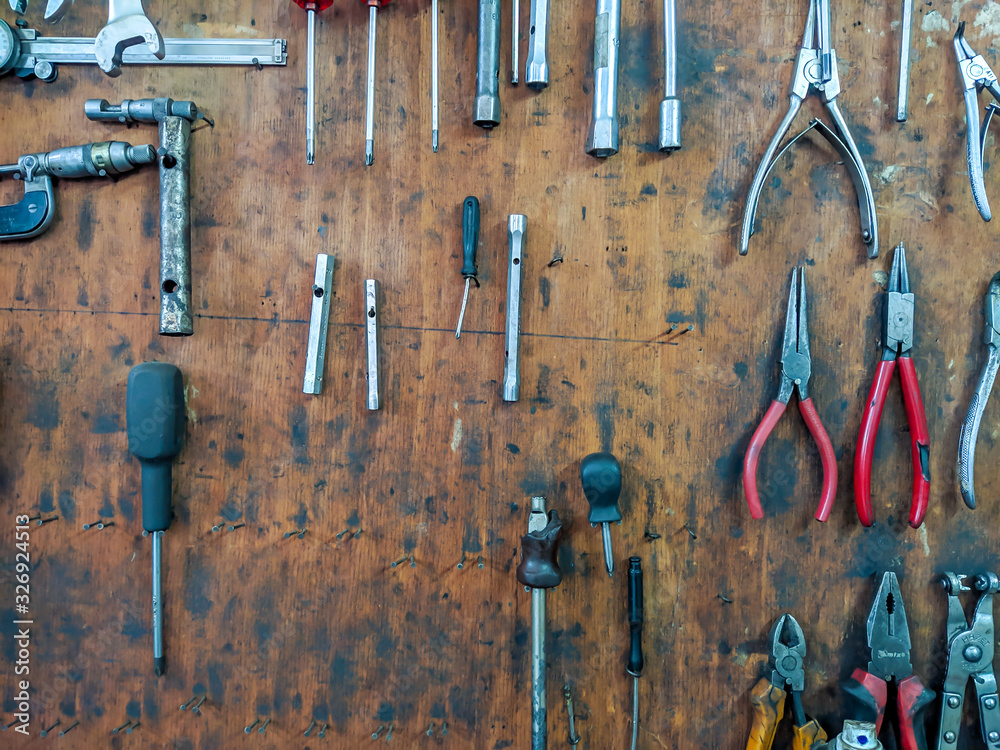 Mechanics tools for repairing an fixing organized on wooden panel board ...