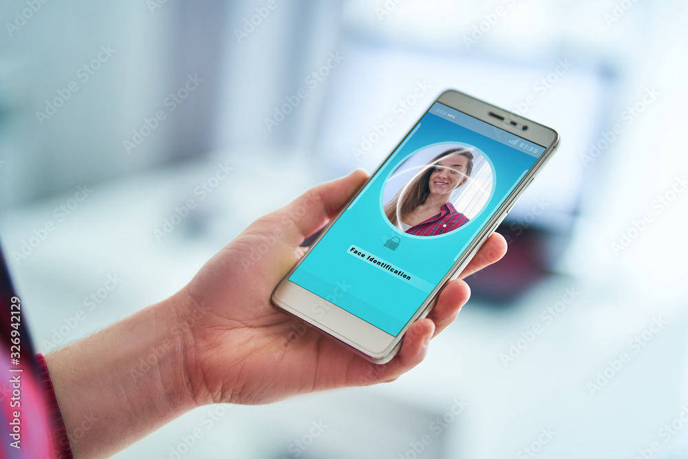 Fotografia do Stock: Woman unlocking smartphone using facial ...