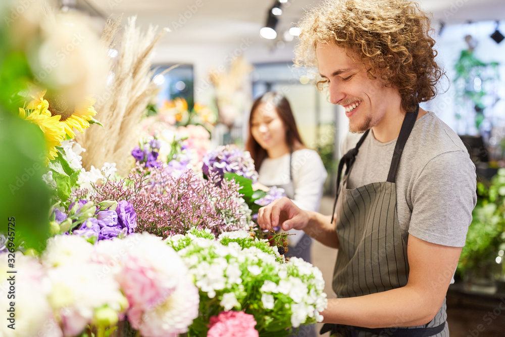 Man as a florist maintains cut flowers assortment Stock Photo | Adobe Stock