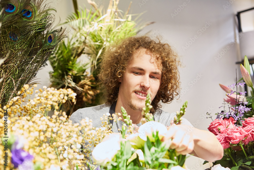 Young man as a florist in training Stock Photo | Adobe Stock