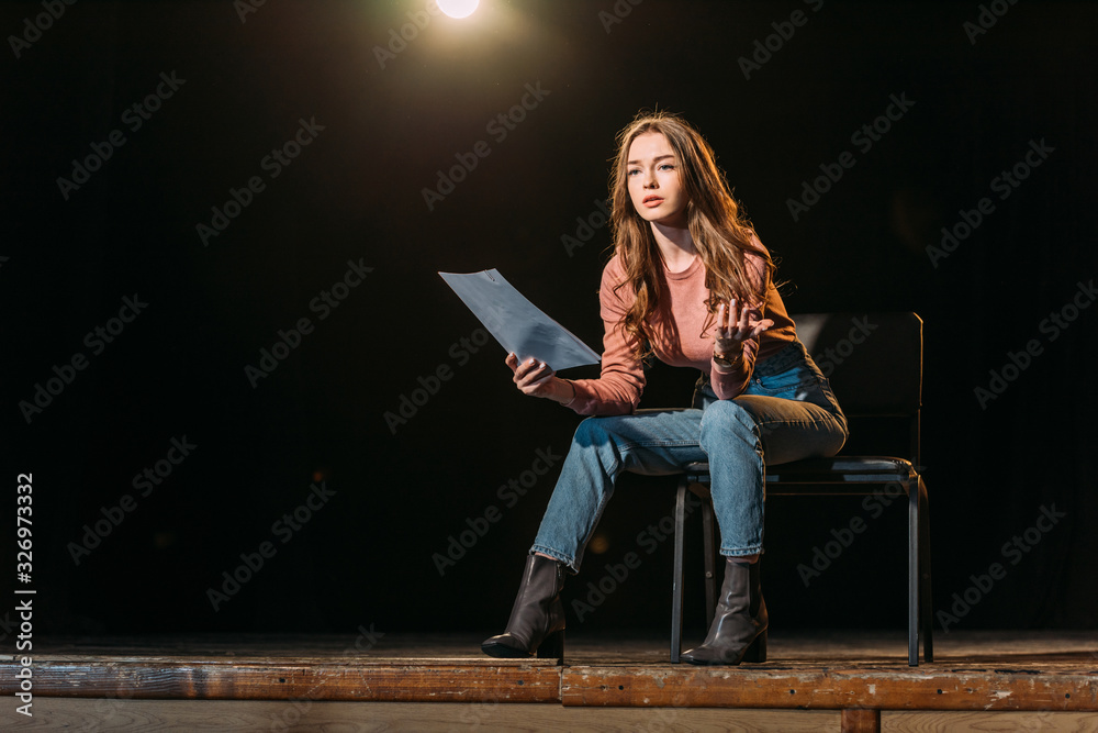 Foto de attractive young actress with scenario performing role on stage ...