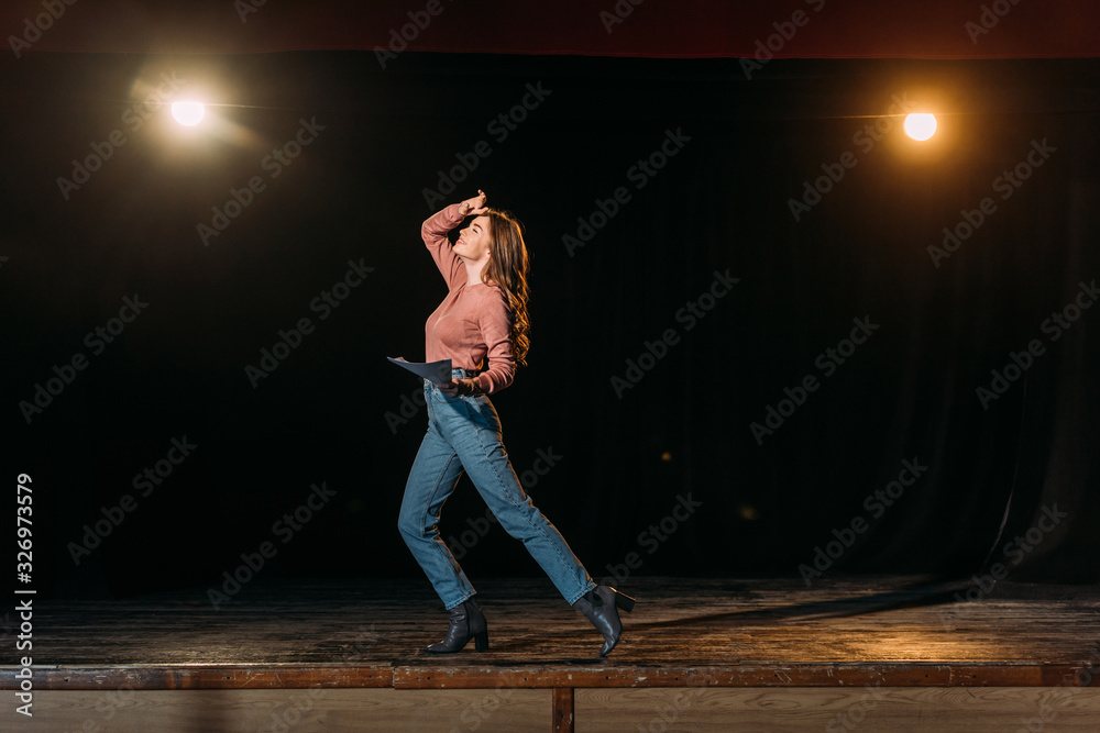 emotional young actress performing role on stage in theatre Stock Photo ...