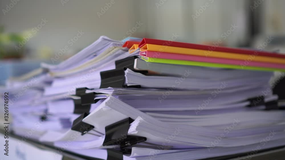 unfinished documents stacks of paper files on office desk for report ...