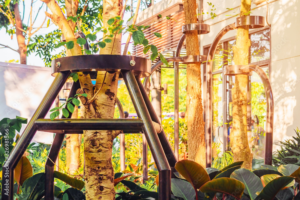 Black steel column supports and controls the branches and trunks of the ...