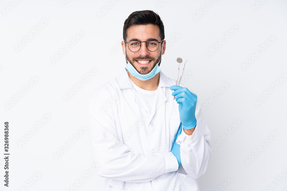 Dentist man holding tools isolated on white background laughing Stock ...