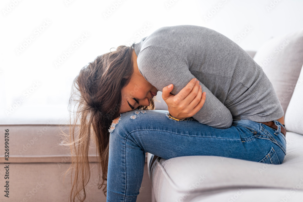 Sad, upset, unhappy woman holding hands on stomach suffering from ...