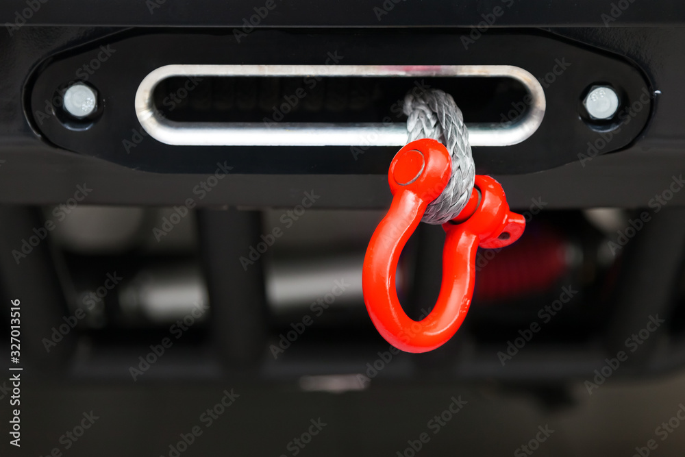 A towing winch with a shackle and a loop on a metal cable mounted on a ...