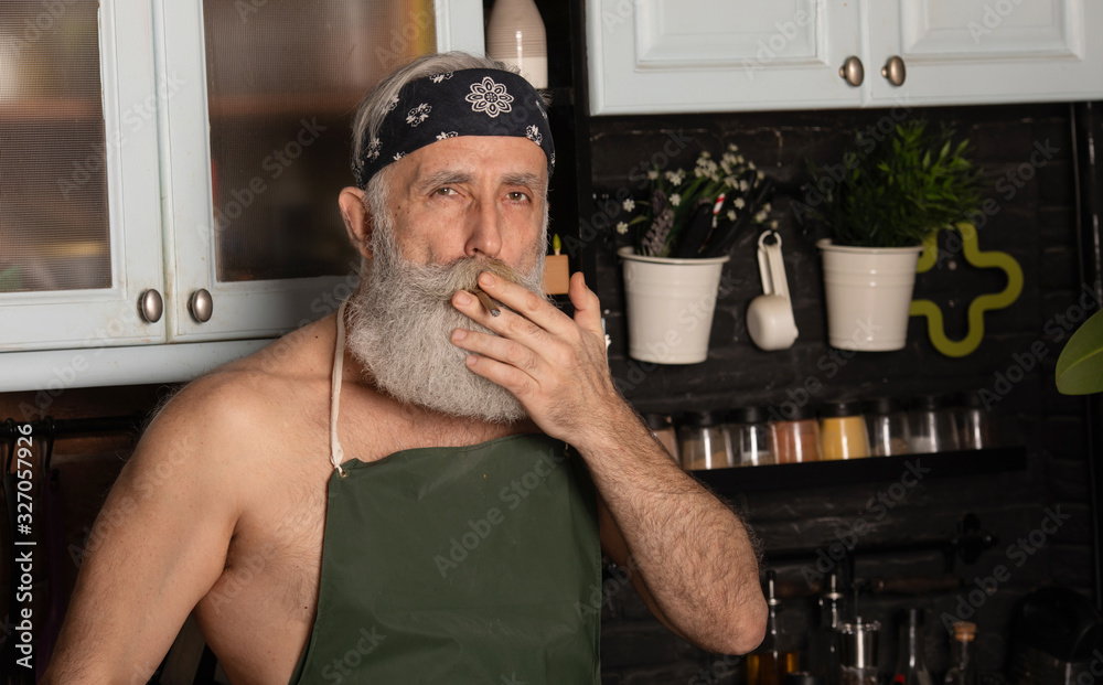 Bearded senior man smoking marijuana (weed, cannabis) at home. Stock ...