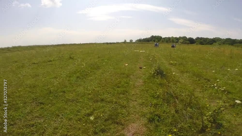 A man runs to a combat target to look at the result shots of a pistol ...