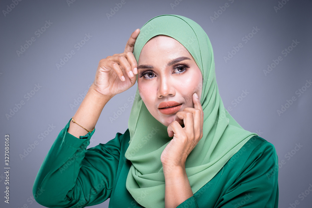 Headshot portrait of a beautiful female Muslim model in modern kurung ...