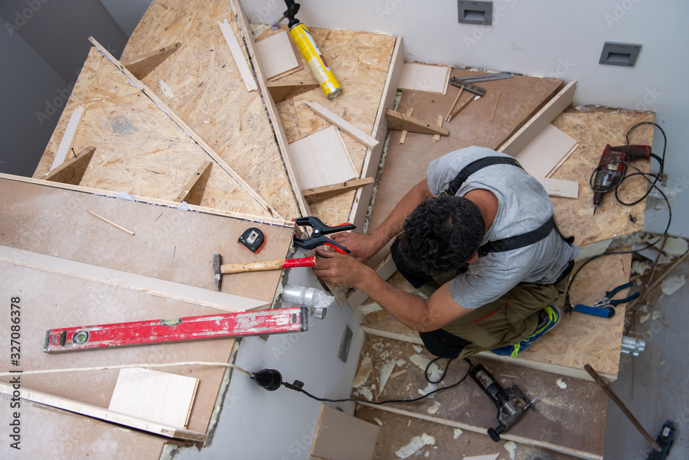 carpenter installing wooden stairs Stock Photo | Adobe Stock