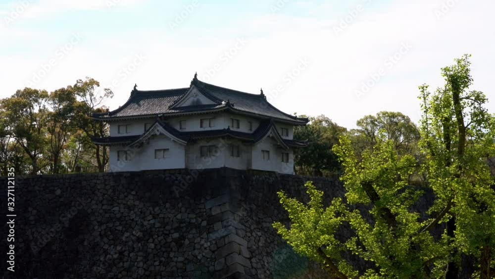 4K, Guard House of main tower Osaka Japanese Castle behind rock wall ...