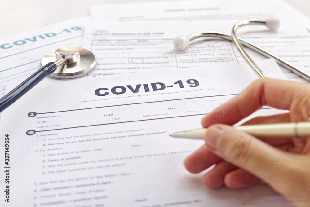COVID-19 Health insurance concept. Blurring of hand holding pen and ...