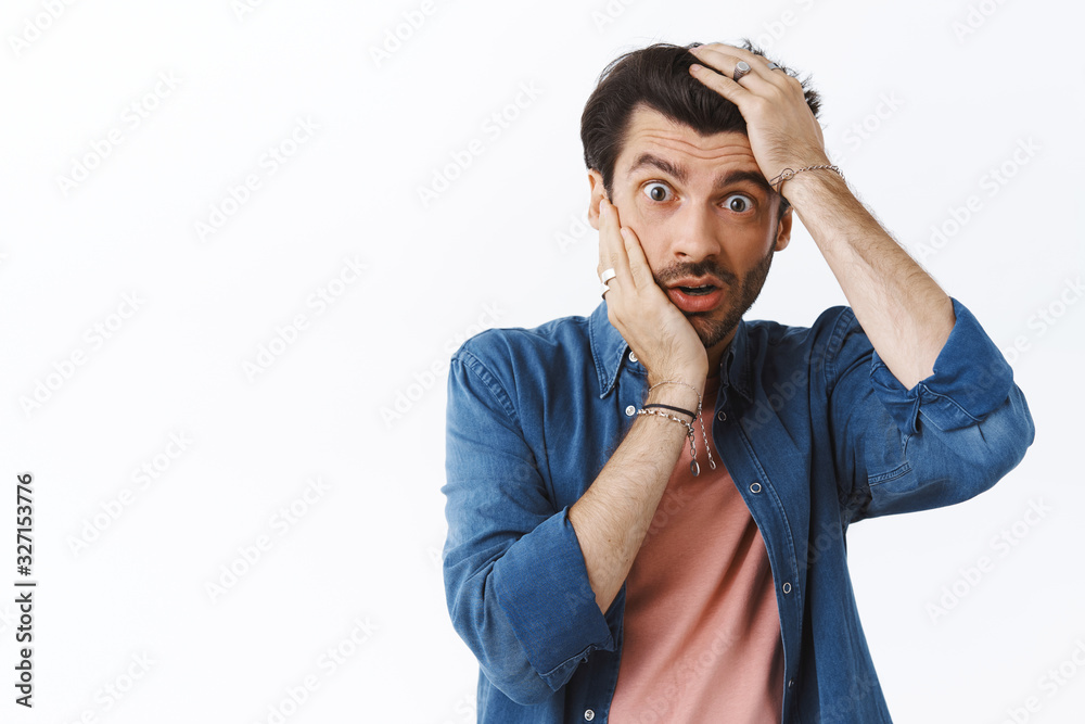 Shocked concerned young man stare speechless and distressed camera ...