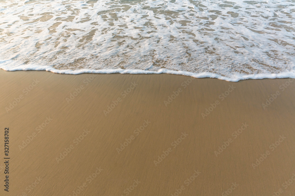 Soft wave of blue ocean on sandy beach. background. selective focus ...