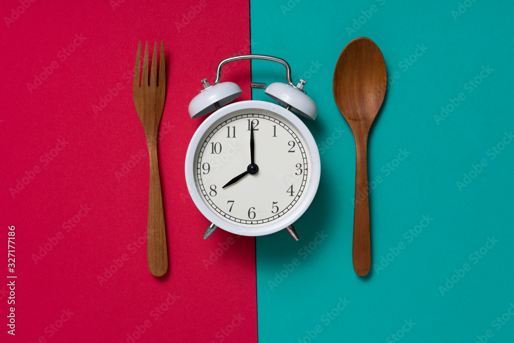 Food clock spoon and fork, Healthy time food concept on green and red ...