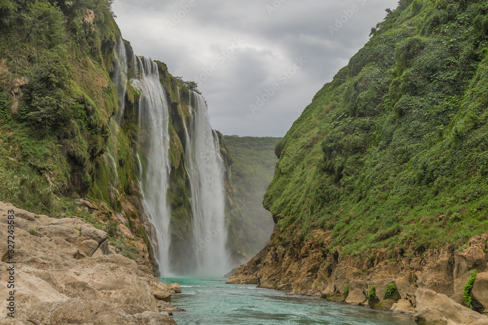 Green Background Scenic view of spectacular Tamul Waterfall, Tampaon ...