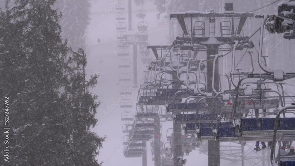 Ski Lift on Ski Resort. Skiers Climb on a Ski Chair Elevator up to Ski ...