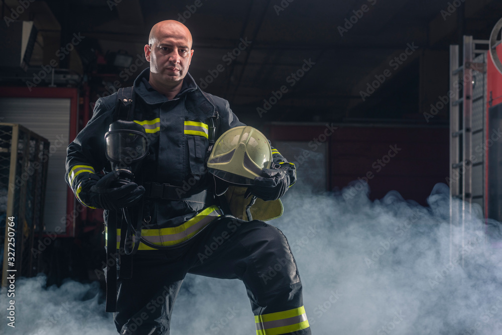 Fireman standing confident holding helmet and wearing firefighter ...