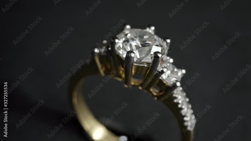 Extreme detailed of diamond ring close up shot while rotating on dark ...