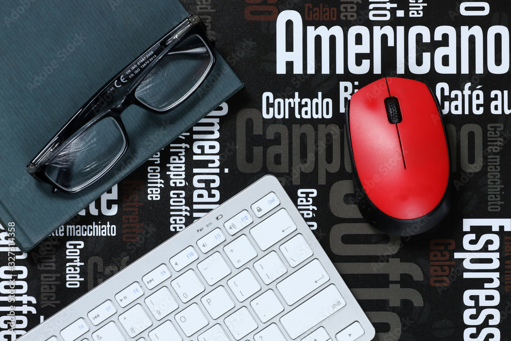 Black glasses on a laptop, book and red mouse isolated on a white ...
