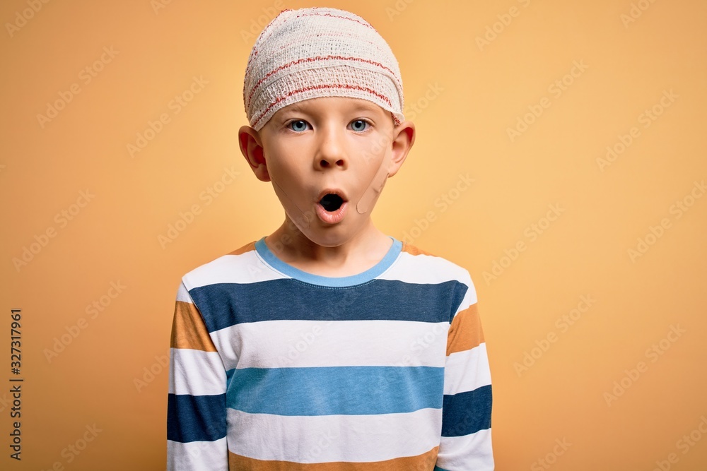 Young little caucasian kid injured wearing medical bandage on head over ...