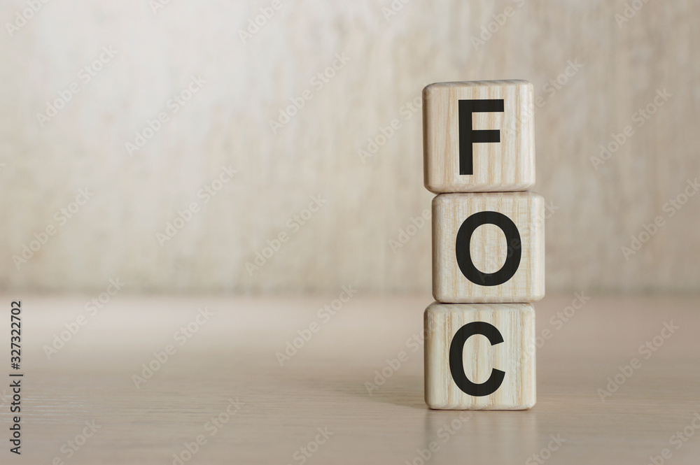 Alphabet letter in word FOC. Abbreviation of Free of charge on wood ...